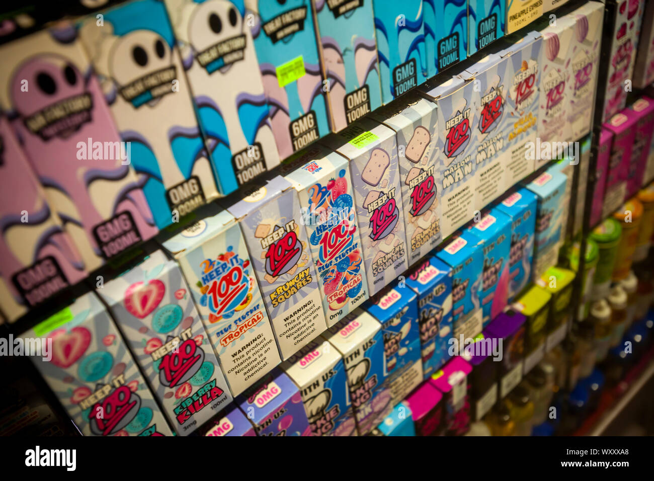 A selection of flavored vaping supplies on display in the window of a ...