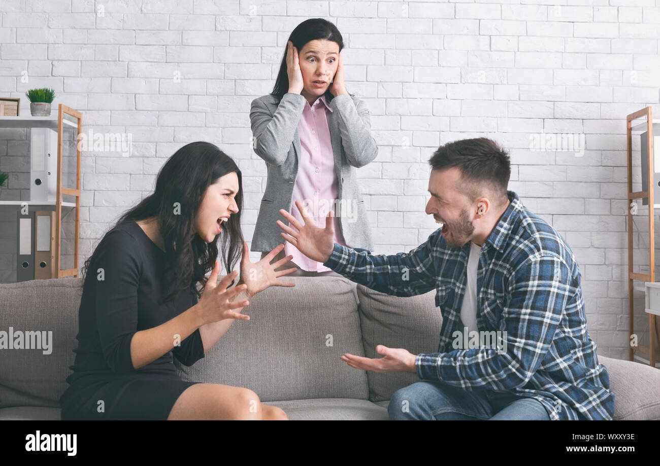 Young aggressive couple shouting at marital therapy Stock Photo - Alamy