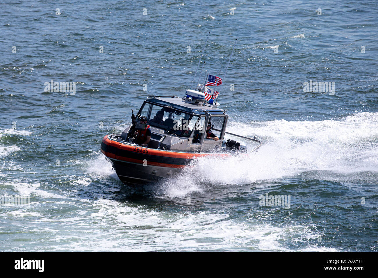 A Coast Guard vessel on patrol following the Staten Island Ferry in New ...