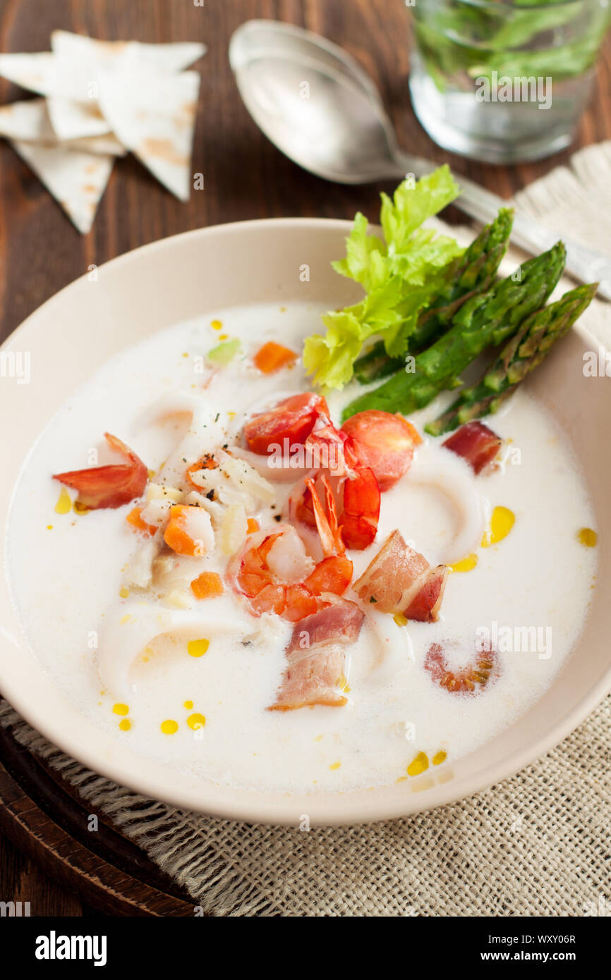 Seafood chowder with calamari, shrimps, bacon, vegetables and asparagus ...