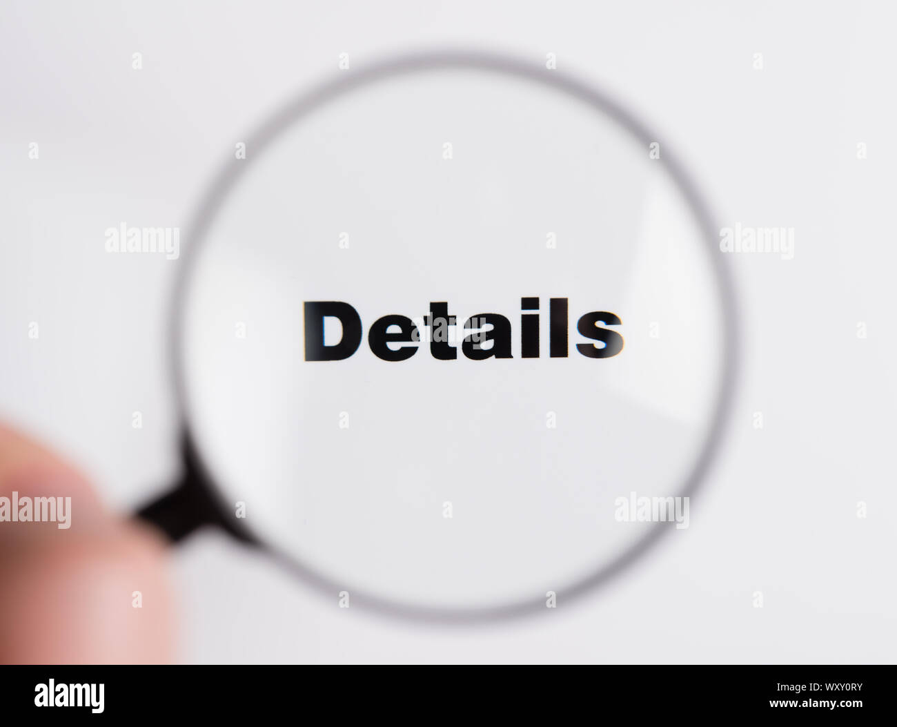 Magnifying glass checking details Stock Photo - Alamy