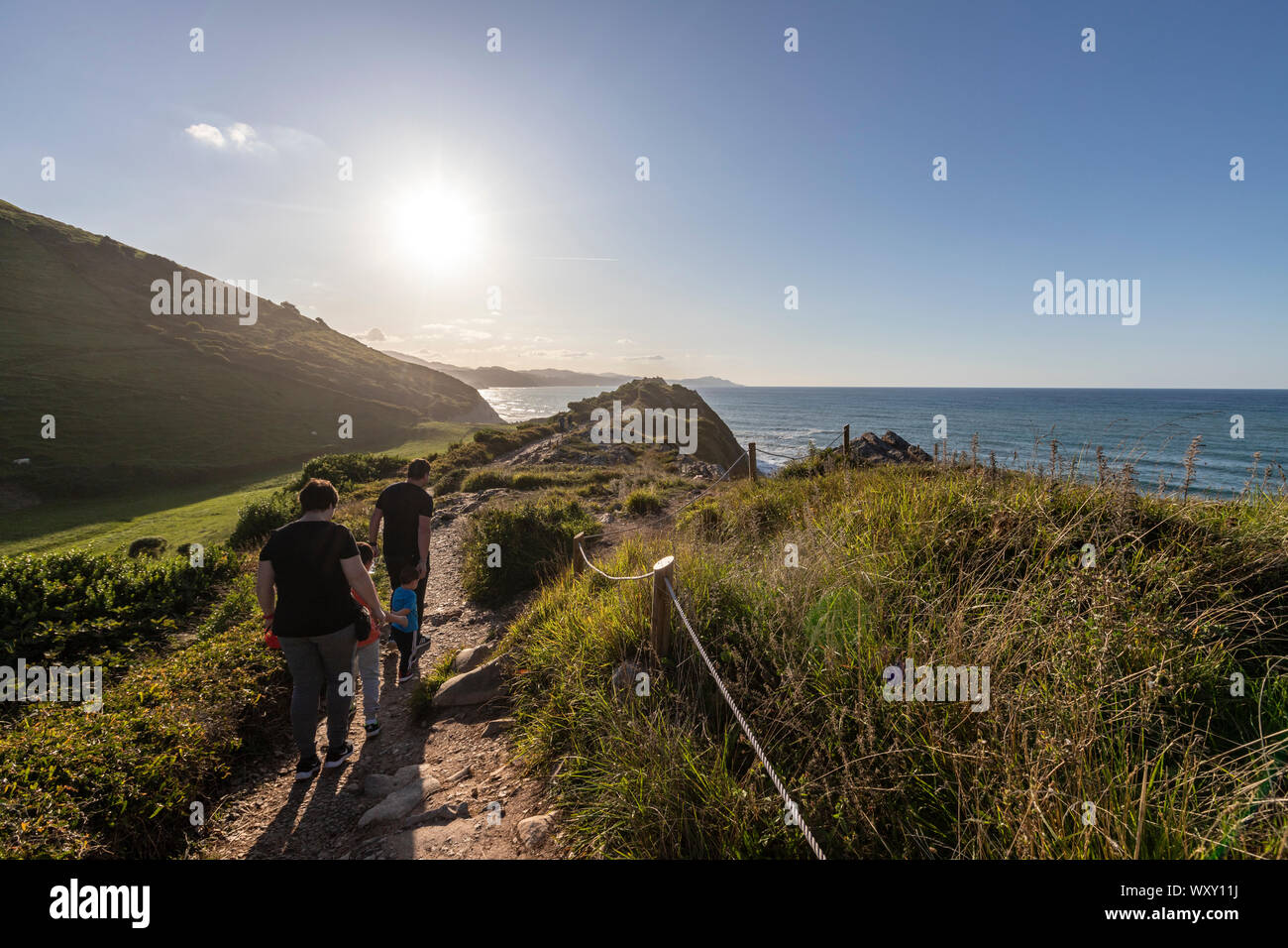 People walking in a path to spectacular coastal scenery, Zumaia, Basque ...