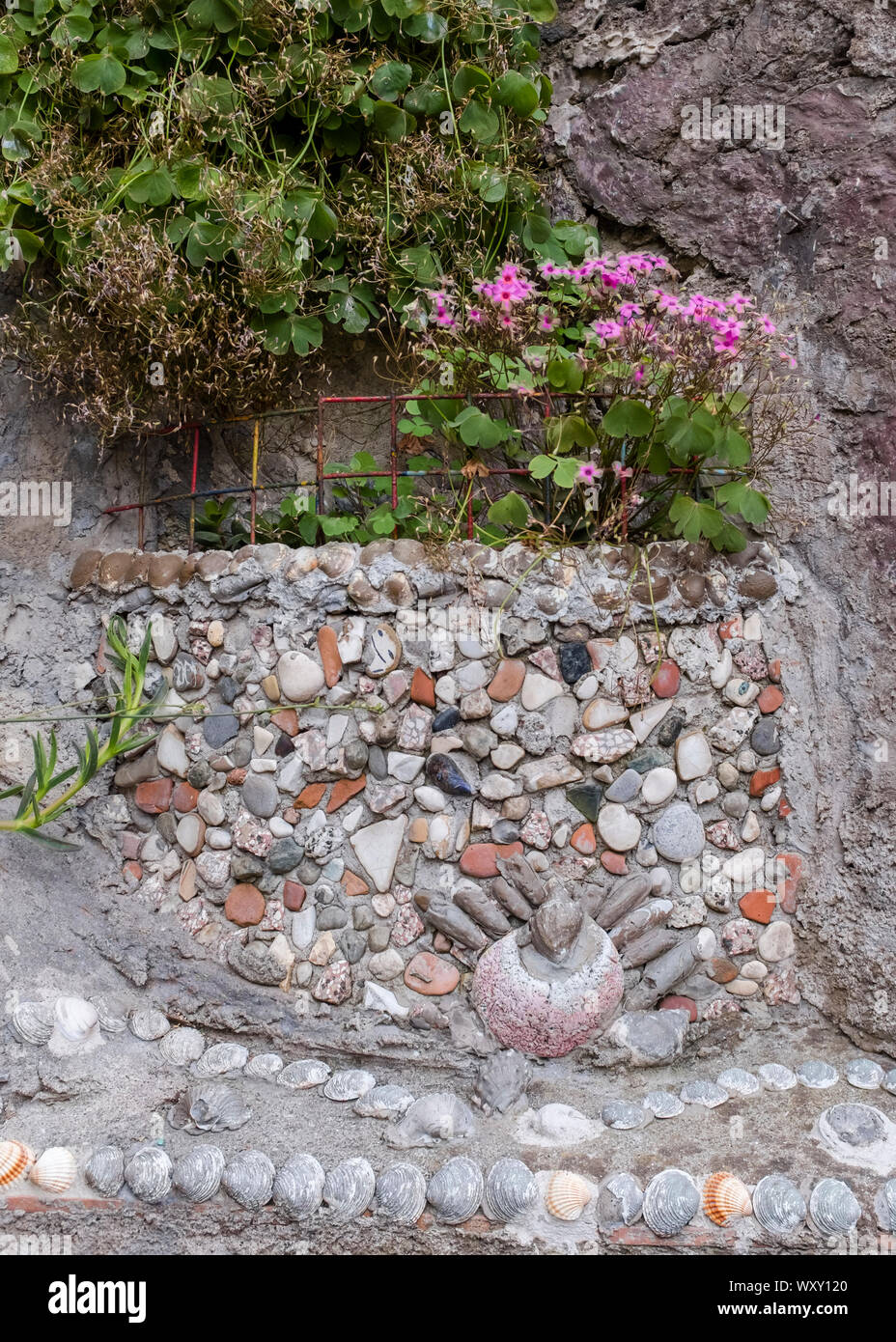 Seashells decorate a wall along a cliffside path in Vernazza, Italy ...