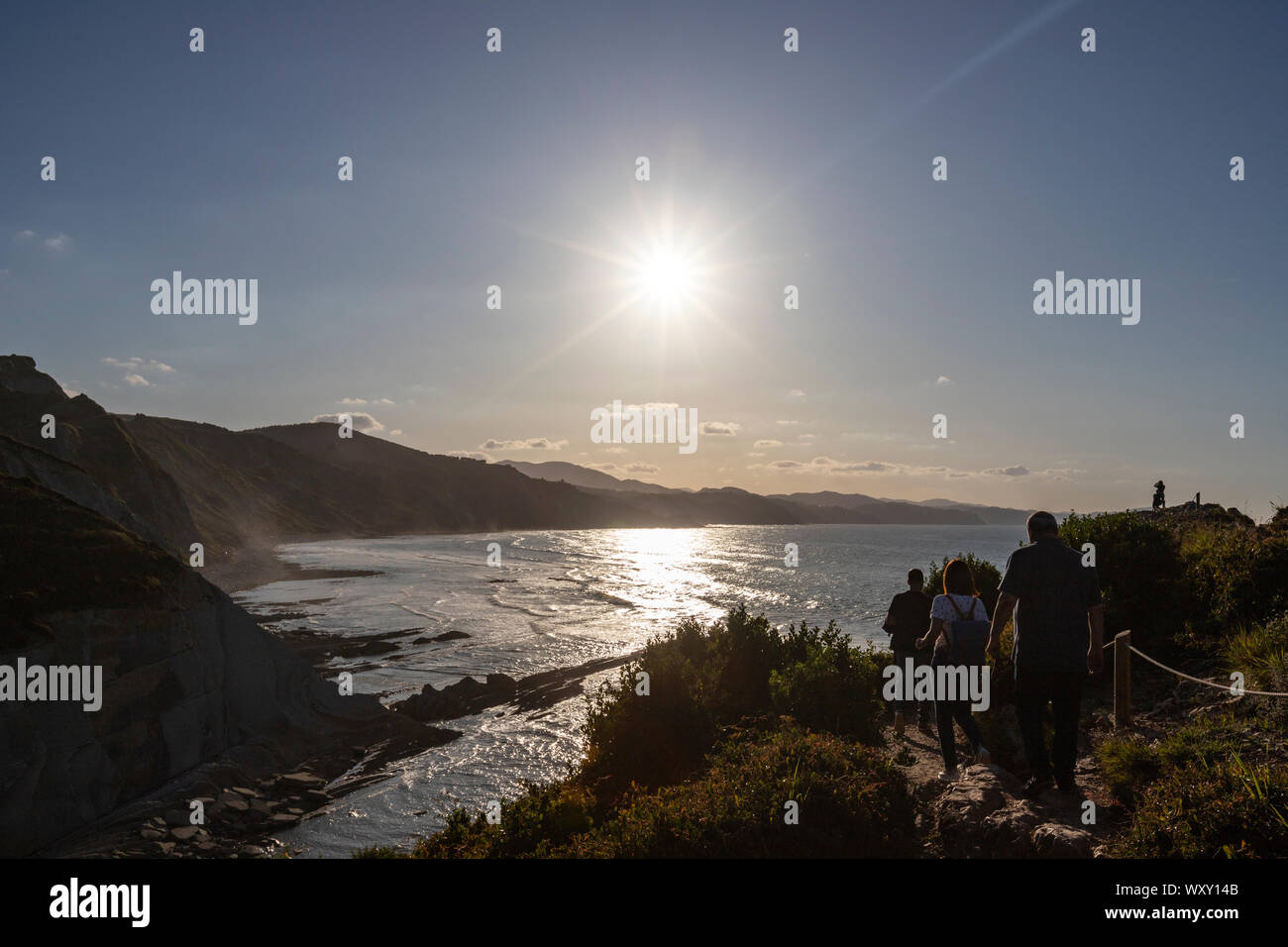 People walking in a path to spectacular coastal scenery, Zumaia, Basque ...