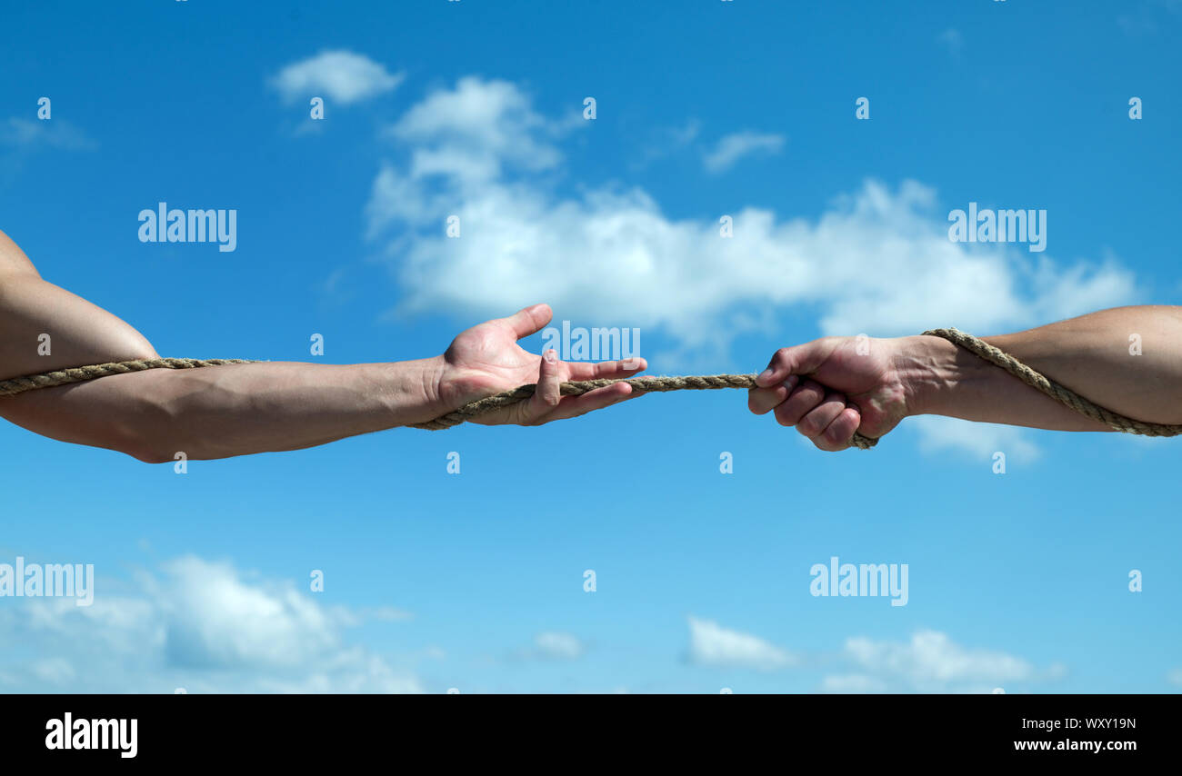 Pulling stronger. Sport competition. Tug war is a sport. Male hands ...