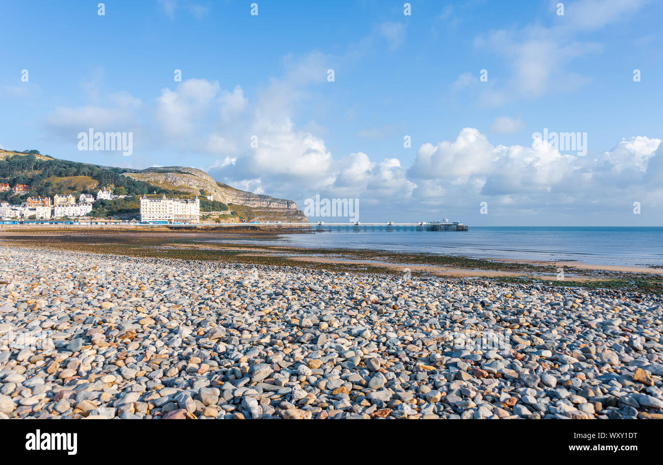 A view of Llandudno’s pier and pebble beach. The Great Orme headland is ...