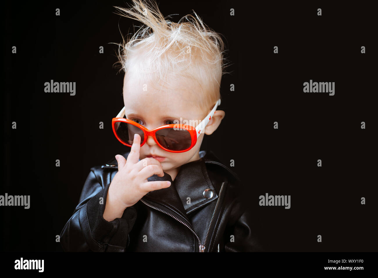 Rock music is a lifestyle. Little child boy in rocker jacket and ...