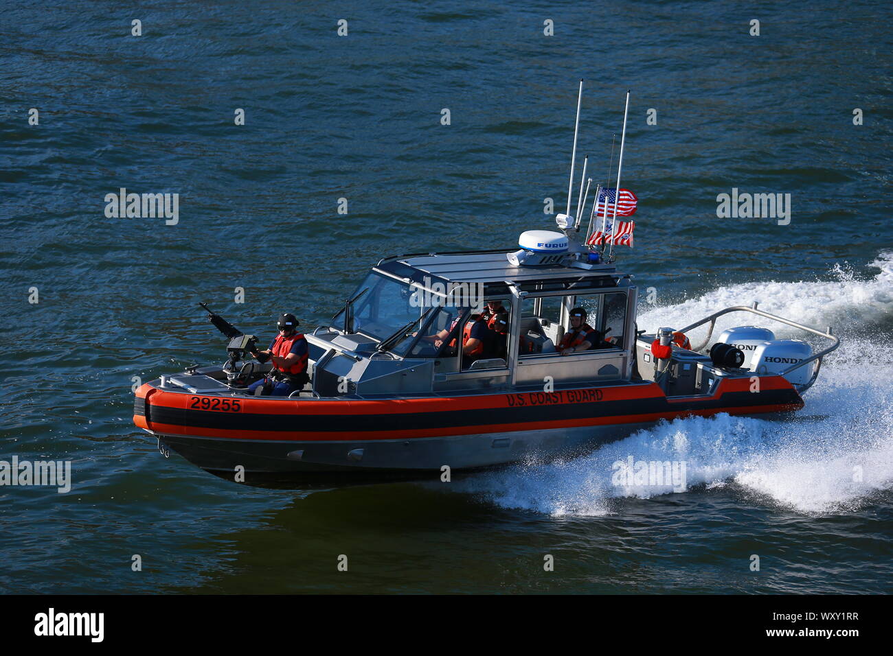 A Coast Guard vessel on patrol following the Staten Island Ferry in New ...