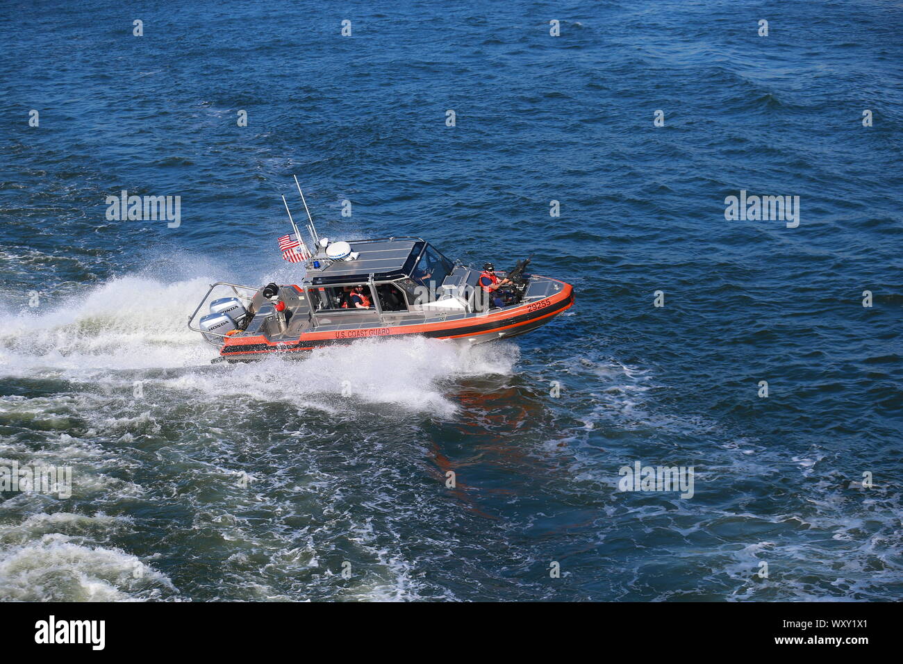 A Coast Guard vessel on patrol following the Staten Island Ferry in New ...