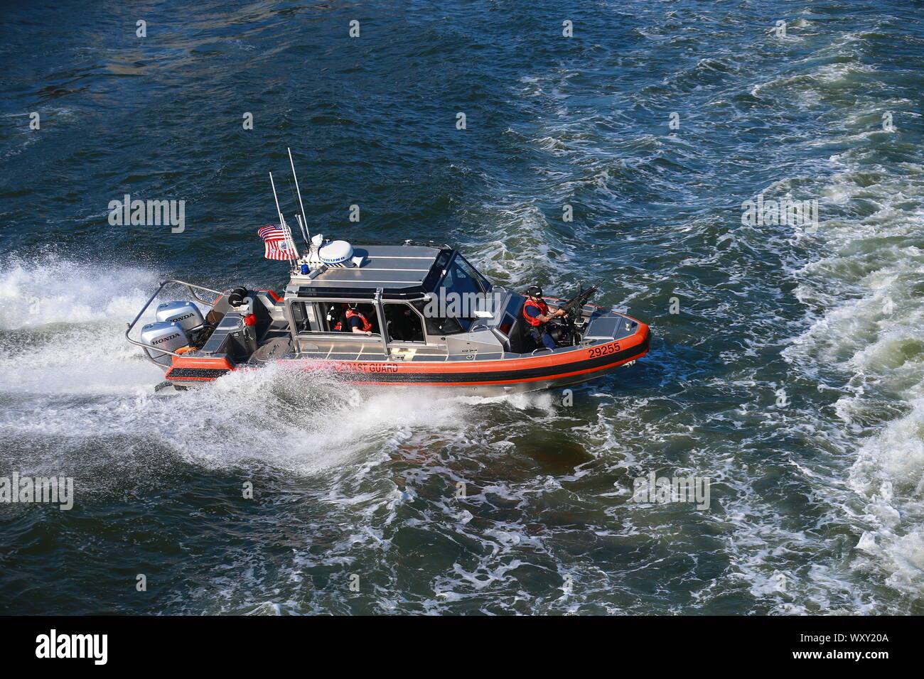 A Coast Guard vessel on patrol following the Staten Island Ferry in New ...
