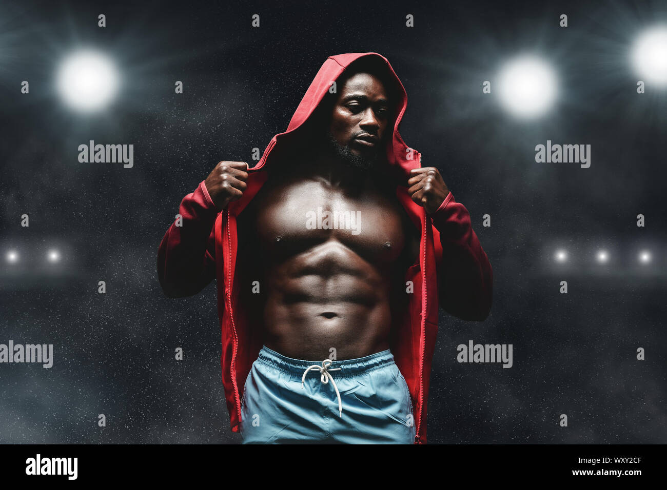 Afro fighter in hoodie at boxing ring Stock Photo - Alamy