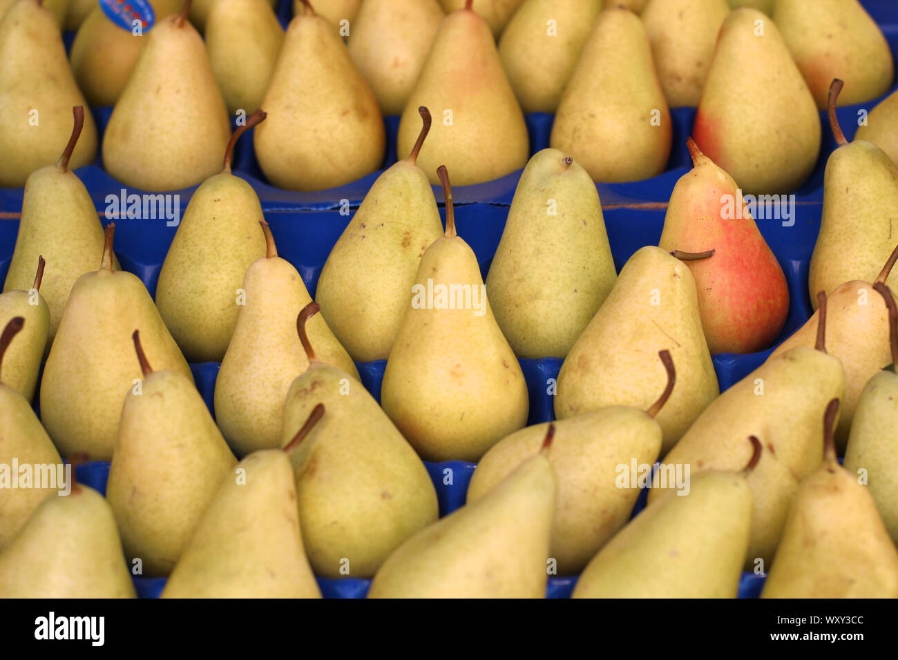 Ripe pears in a box with cells on the market counter Stock Photo - Alamy