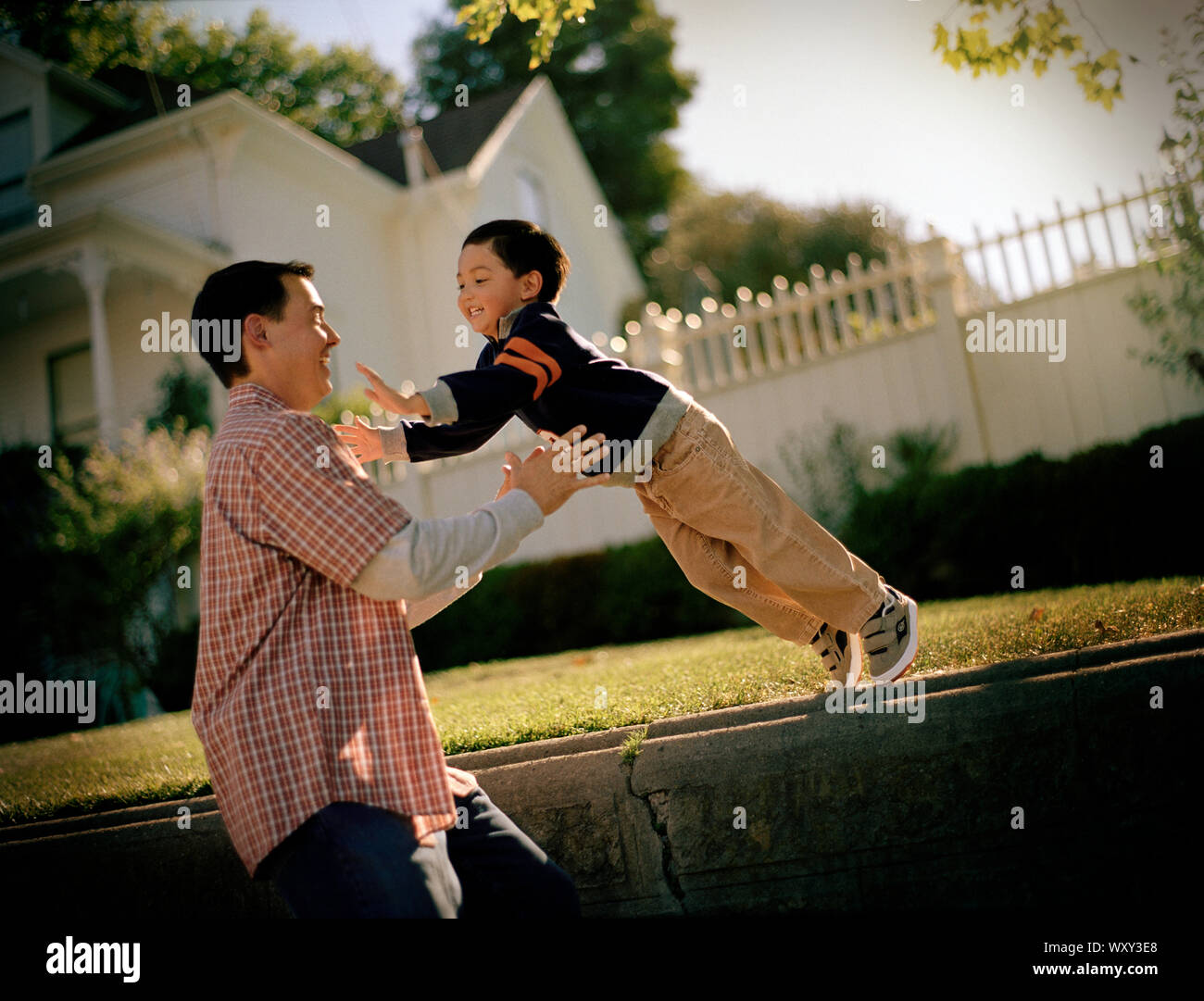 little boy jumping into father?s arms Stock Photo - Alamy