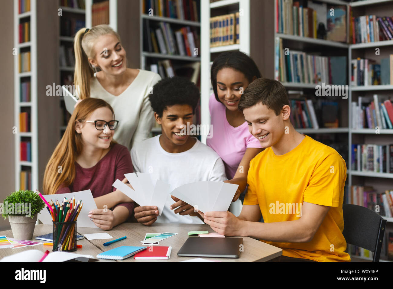 Happy graphic designers checking on colors for new project Stock Photo ...