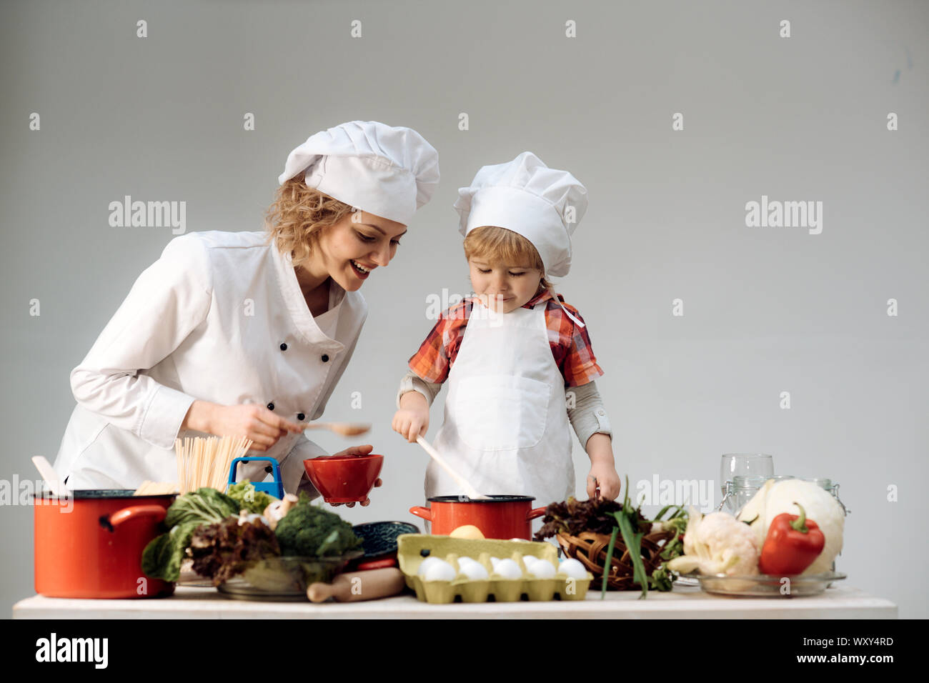 Chef and assistant near kitchen equipment and food products Stock Photo ...