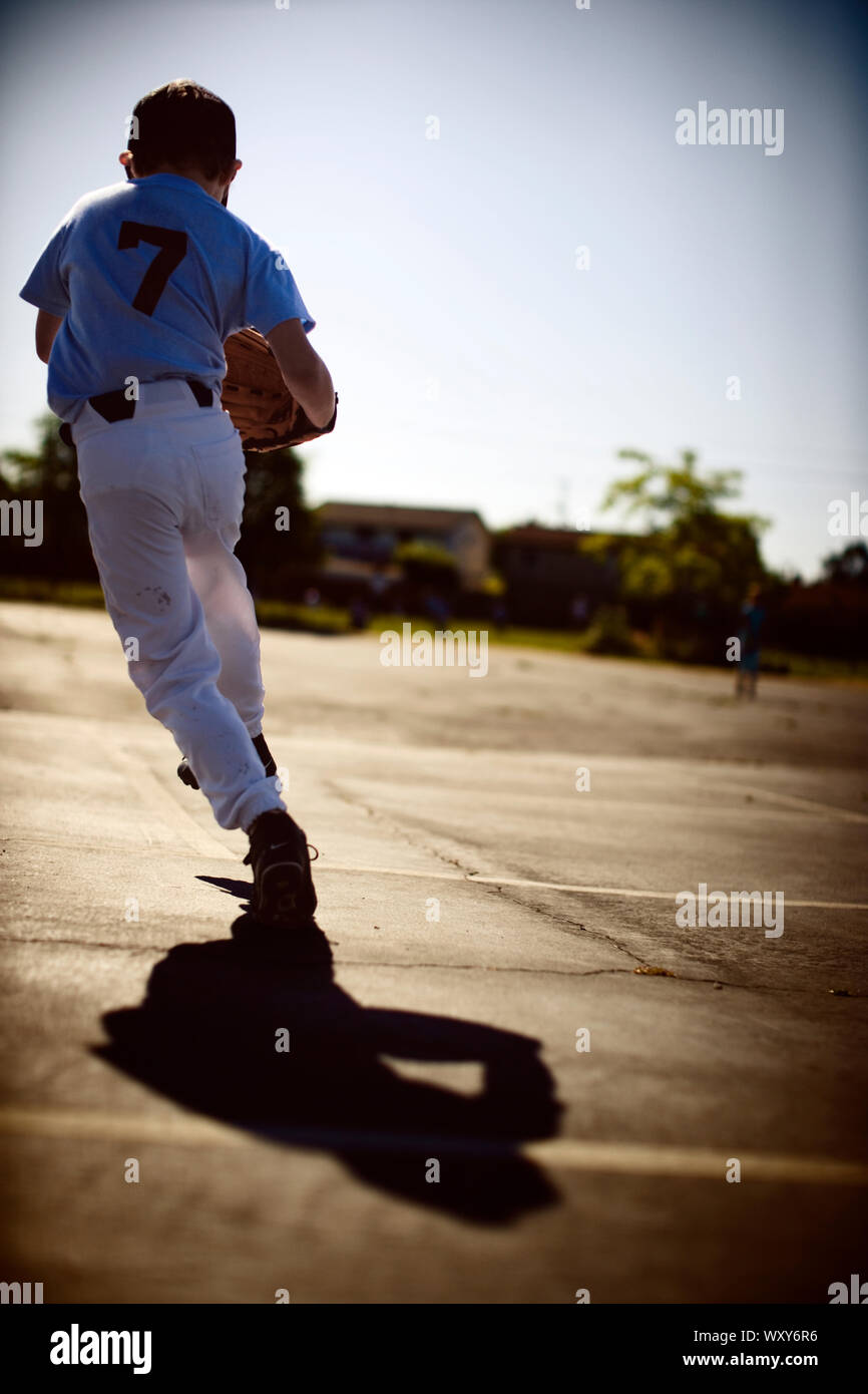 Rear view of a boy playing baseball Stock Photo - Alamy