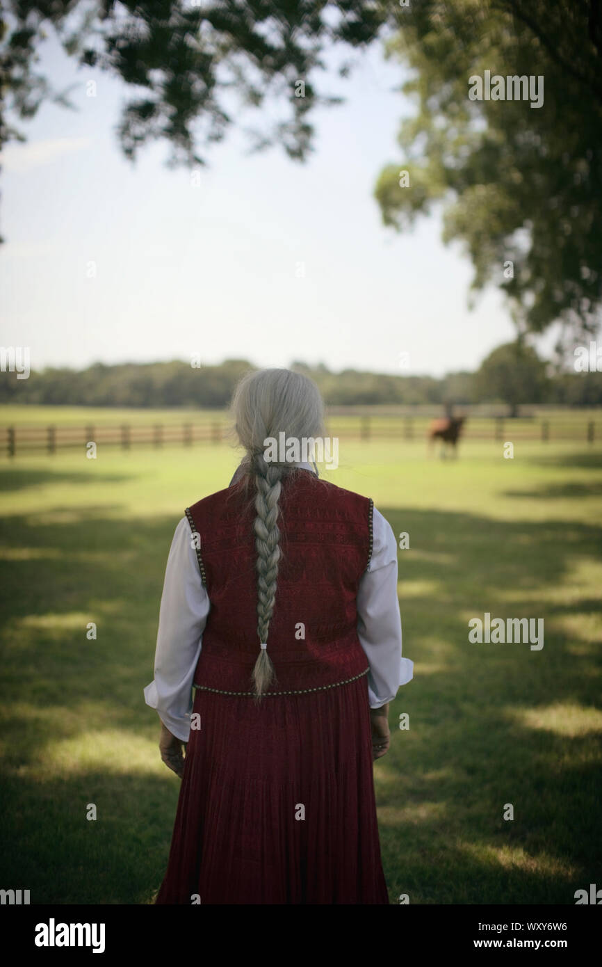 Rear view of an old lady with a long braid Stock Photo - Alamy