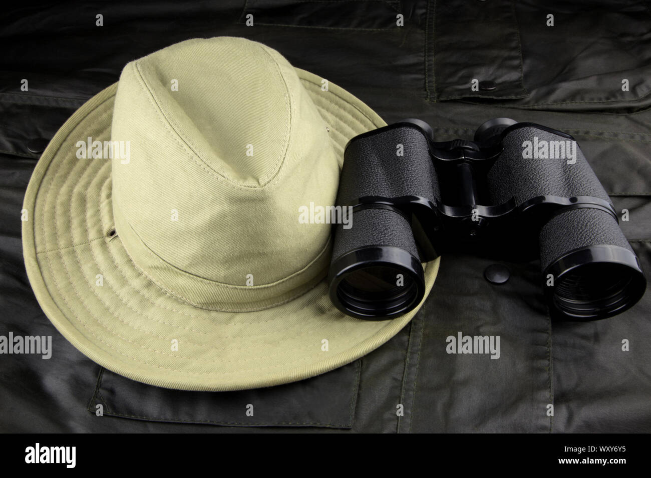Bush hat and binoculars on an outdoor waxed coat Stock Photo - Alamy