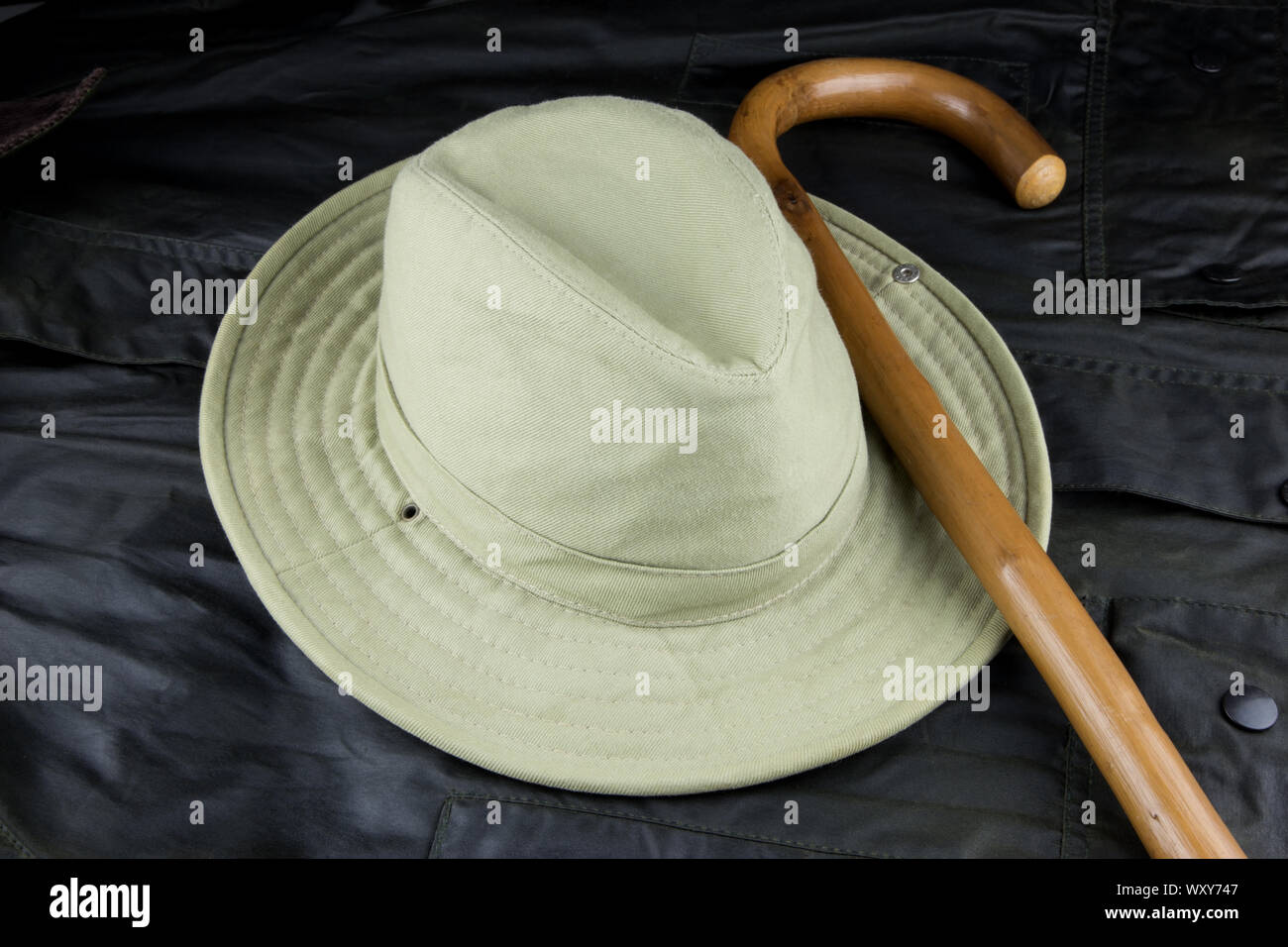 Bush hat and walking stick on a waxed outdoor jacket Stock Photo - Alamy