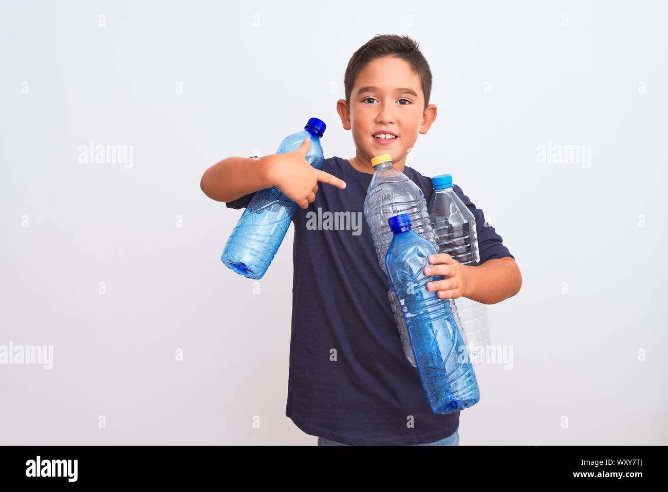 Beautiful kid boy recycling plastic bottles standing over isolated ...