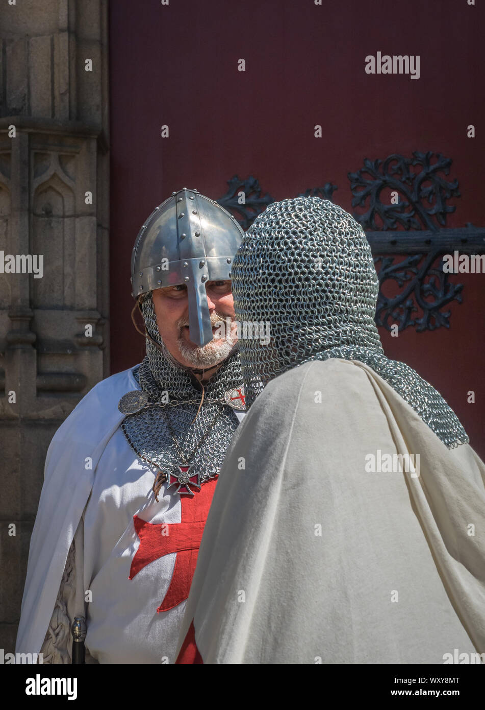 Two men dressed as Christian crusaders with chain mail talking at the ...
