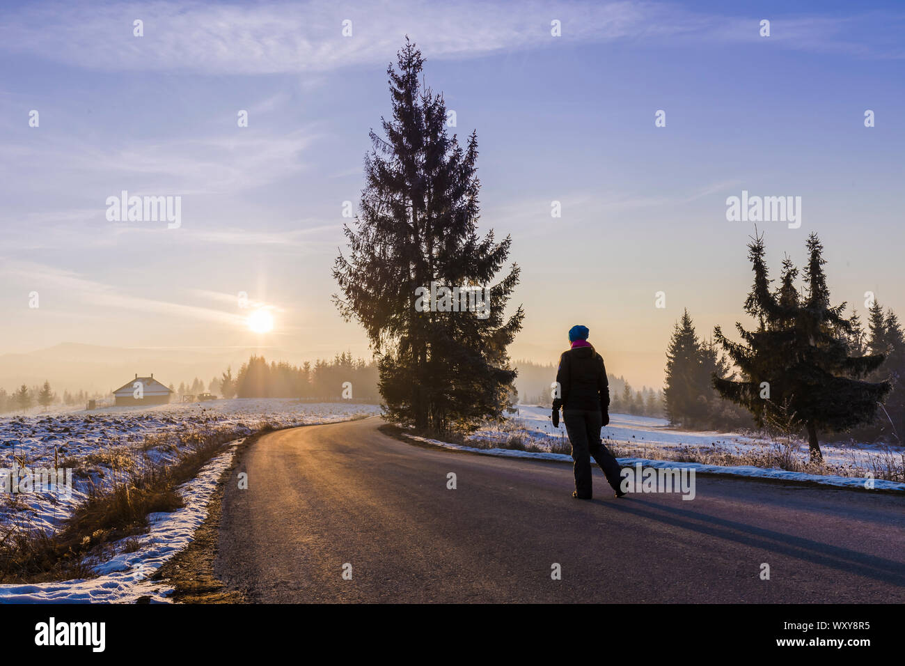 Girl exploring in winter evening Stock Photo - Alamy