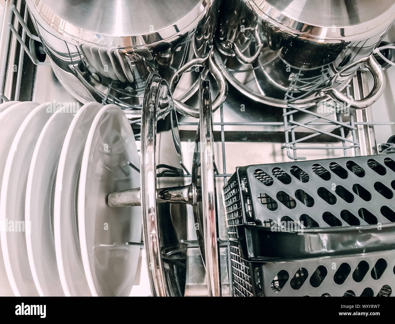 Open dishwasher machine with white clean dishes close up. Mobile photo ...