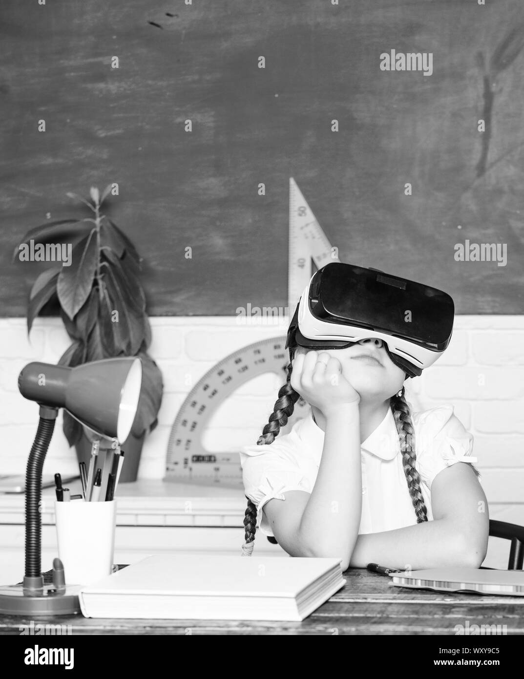 Little girl wearing virtual reality goggles. back to school. Little ...