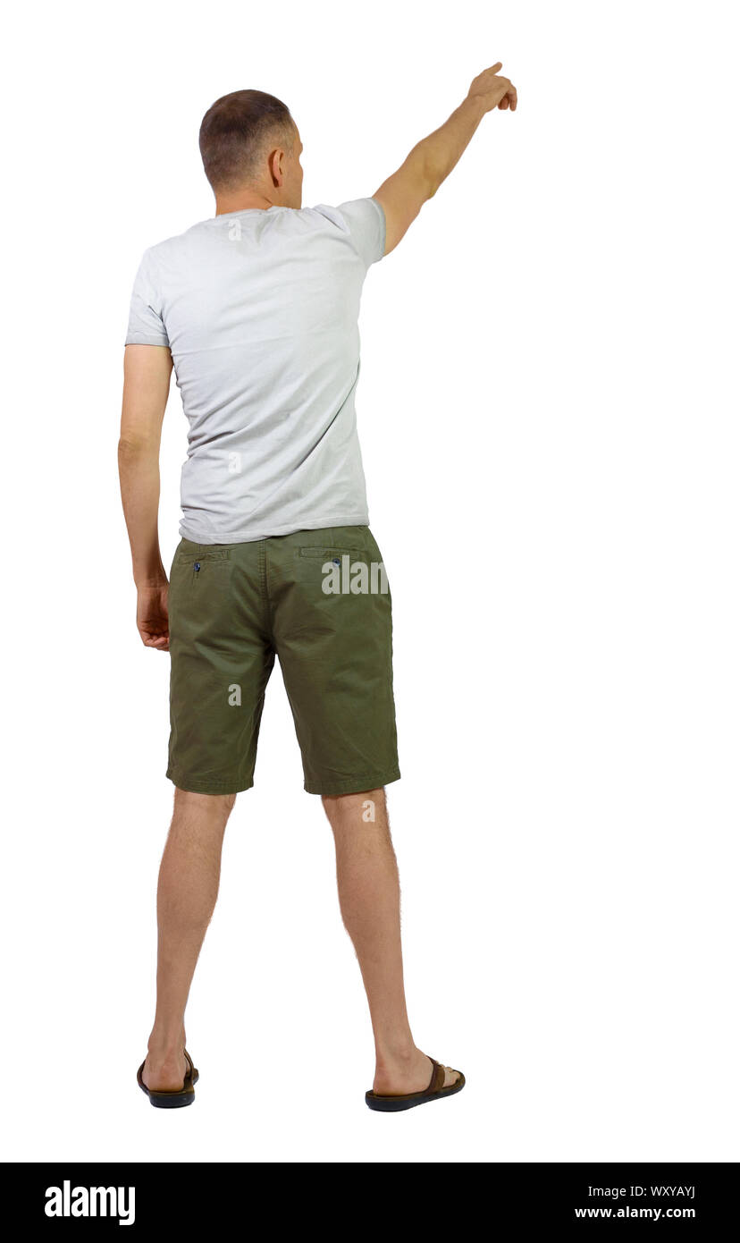 Back view of going handsome man in shorts pointing. walking young guy ...