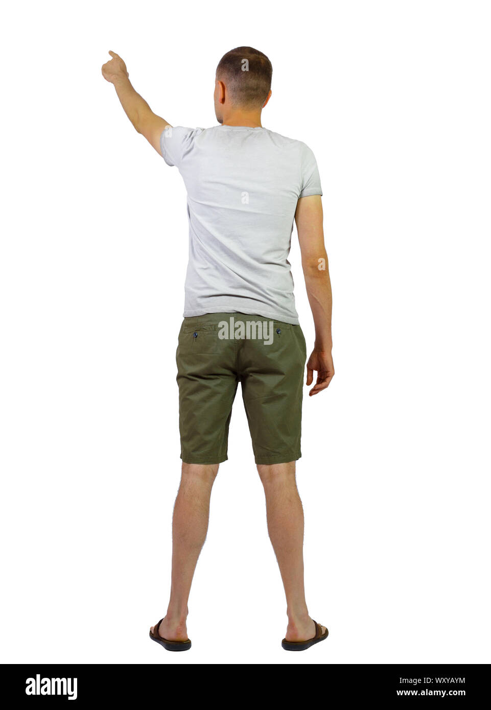 Back view of going handsome man in shorts pointing. walking young guy ...