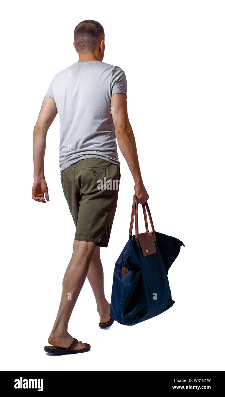 back view of walking man with blue bag. brunette guy in motion ...