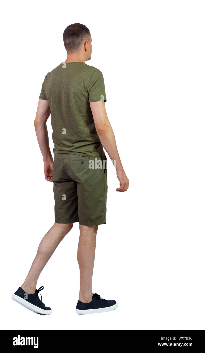 Back view of going handsome man in shorts. walking young guy . Rear ...