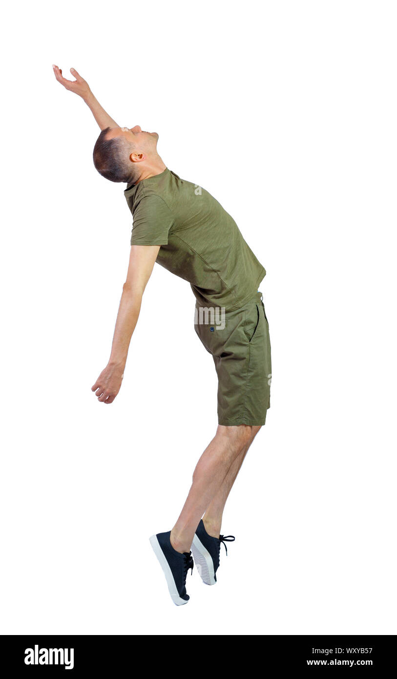 Side view of a man dancing in shorts. The guy is balancing. Rear view ...