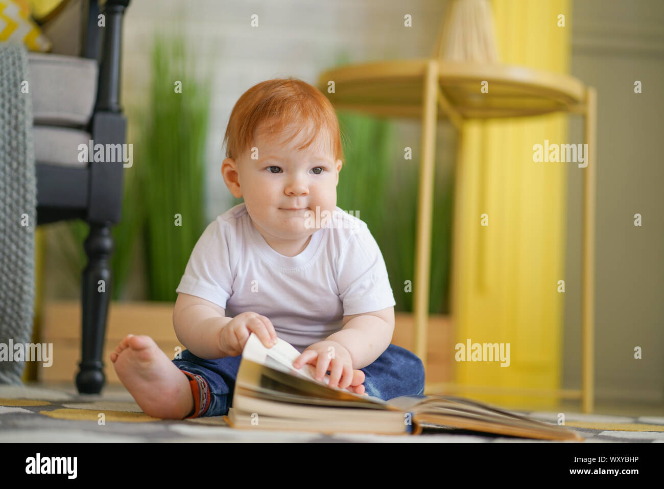 little infant Boy reading a book, educating concept Stock Photo - Alamy