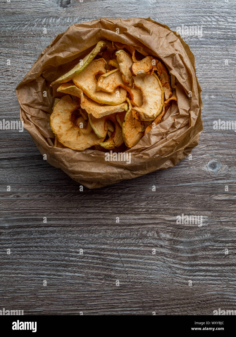 Homemade dried organic apple sliced on wood background Stock Photo - Alamy