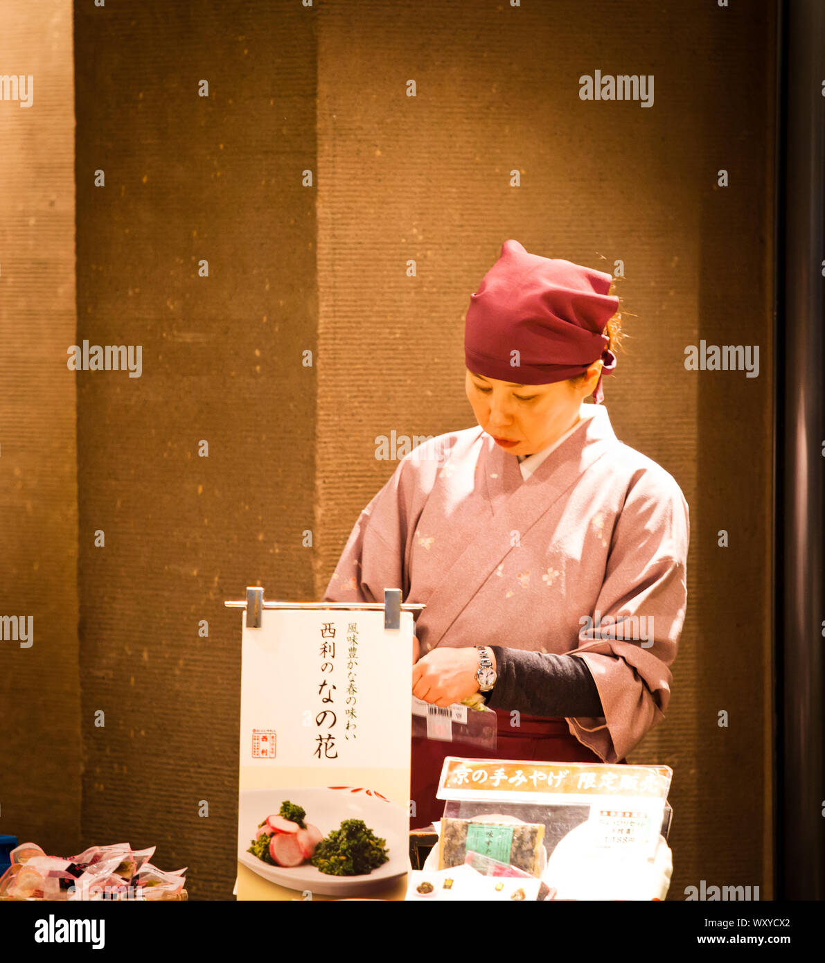 Shop worker in a Japanese food shop wearing the traditional tenuous ...
