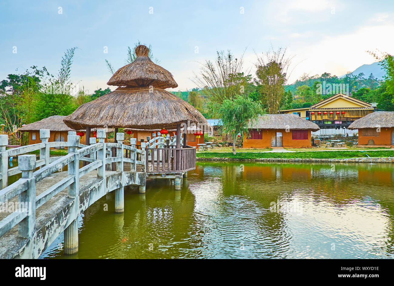 The banks of the small pond are connected with scenic bridge with ...