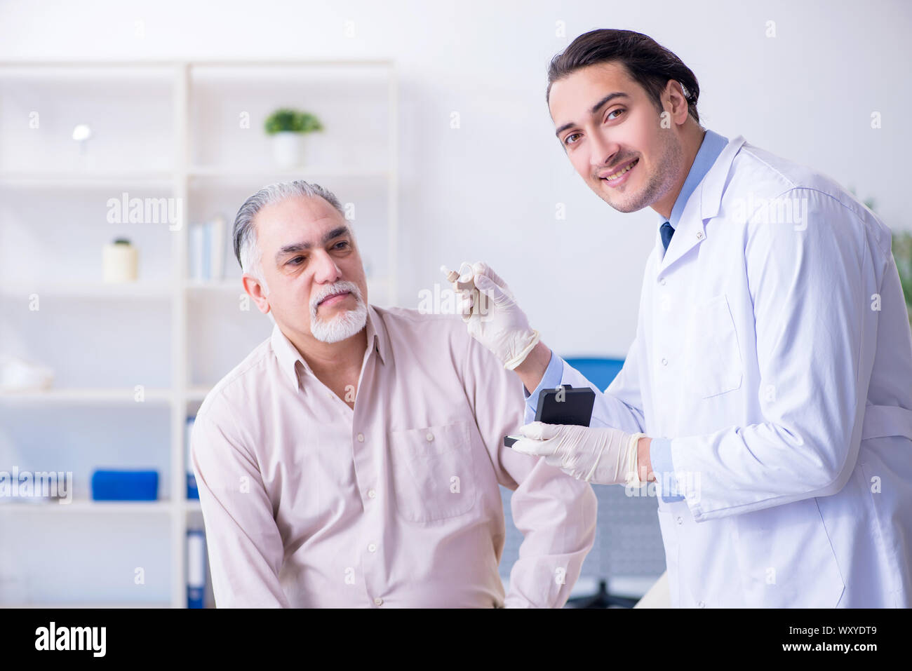 Male patient with hearing problem visiting doctor otorhinolaryngologist ...