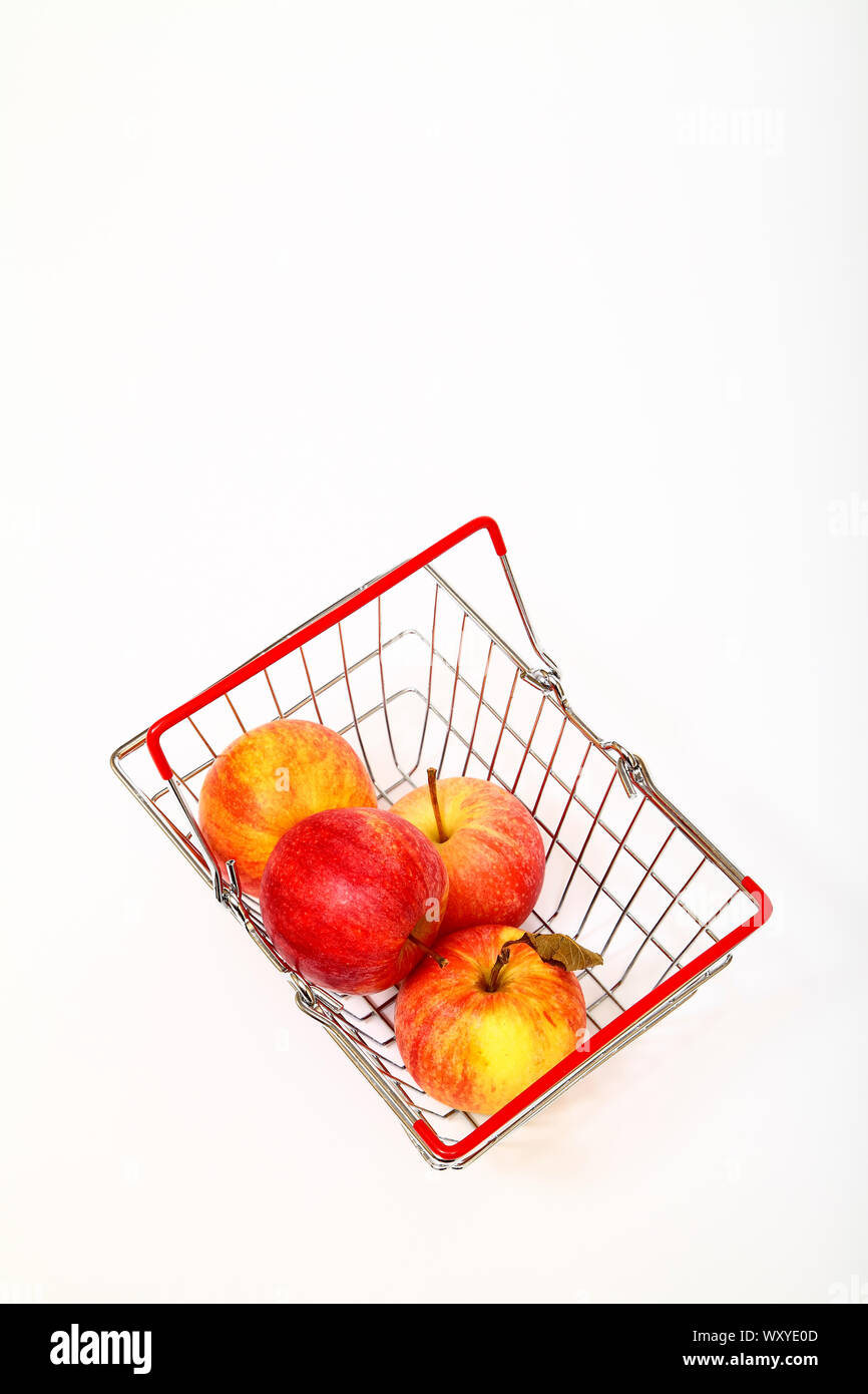 Miniature metal wire basket filled with ripe red eating apples isolated ...