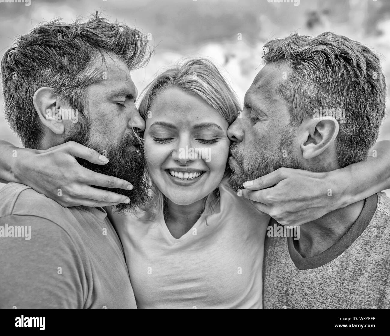 She likes male attention. Girl hugs with two guys. Love triangle ...