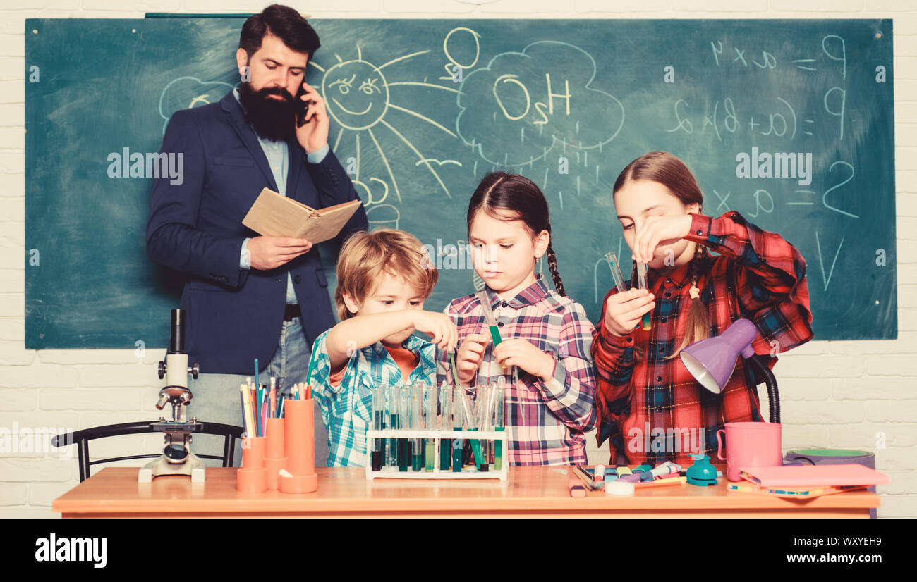 back to school. kids in lab coat learning chemistry in school ...