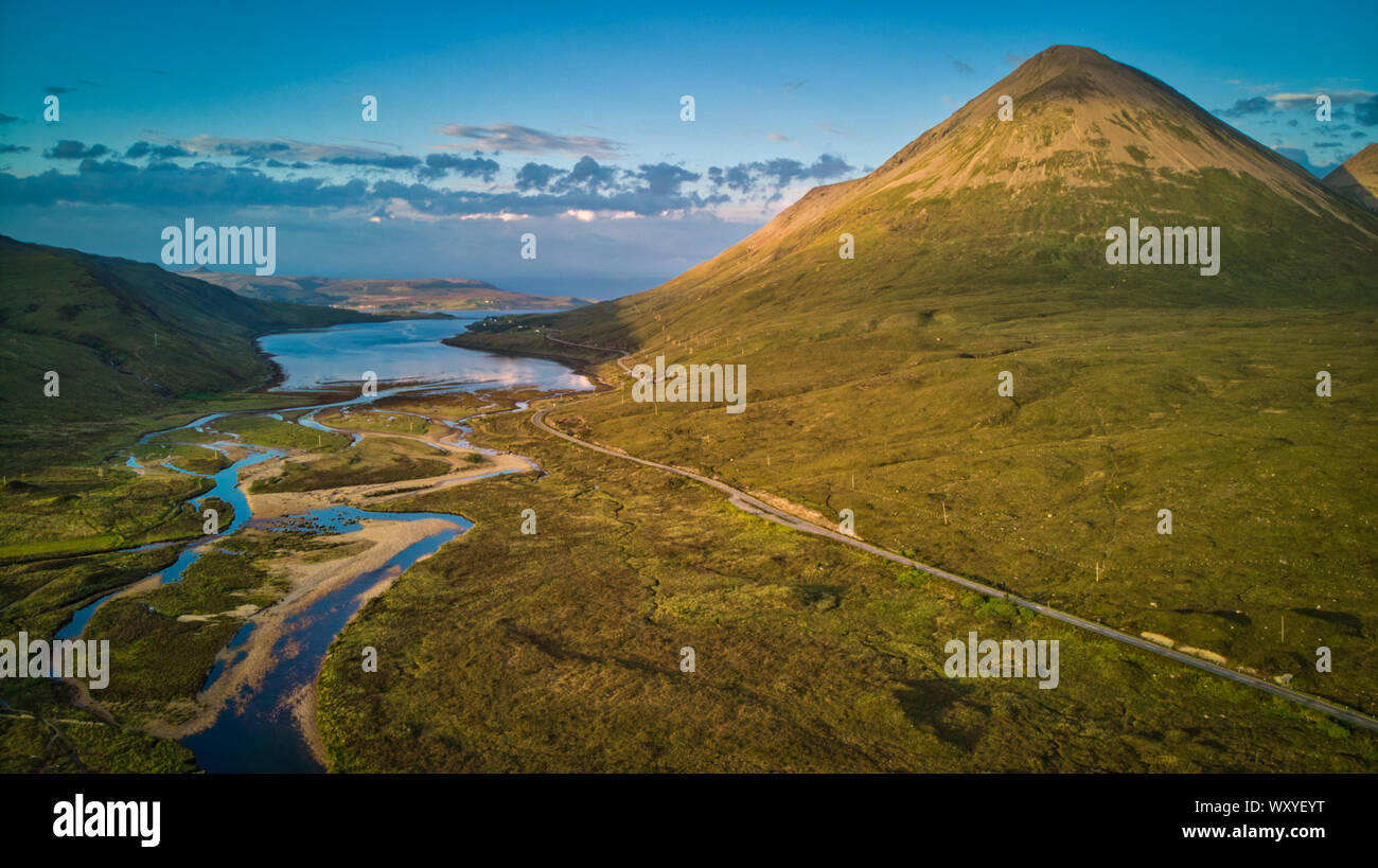A cone-shaped hill of Glamaig, Red Hills, raising above Loch Sligachan ...
