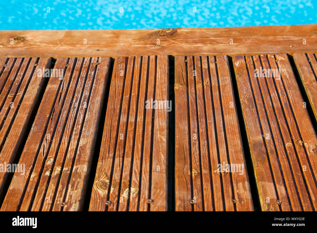 close up on swimming pool with treated wood damaged Stock Photo - Alamy