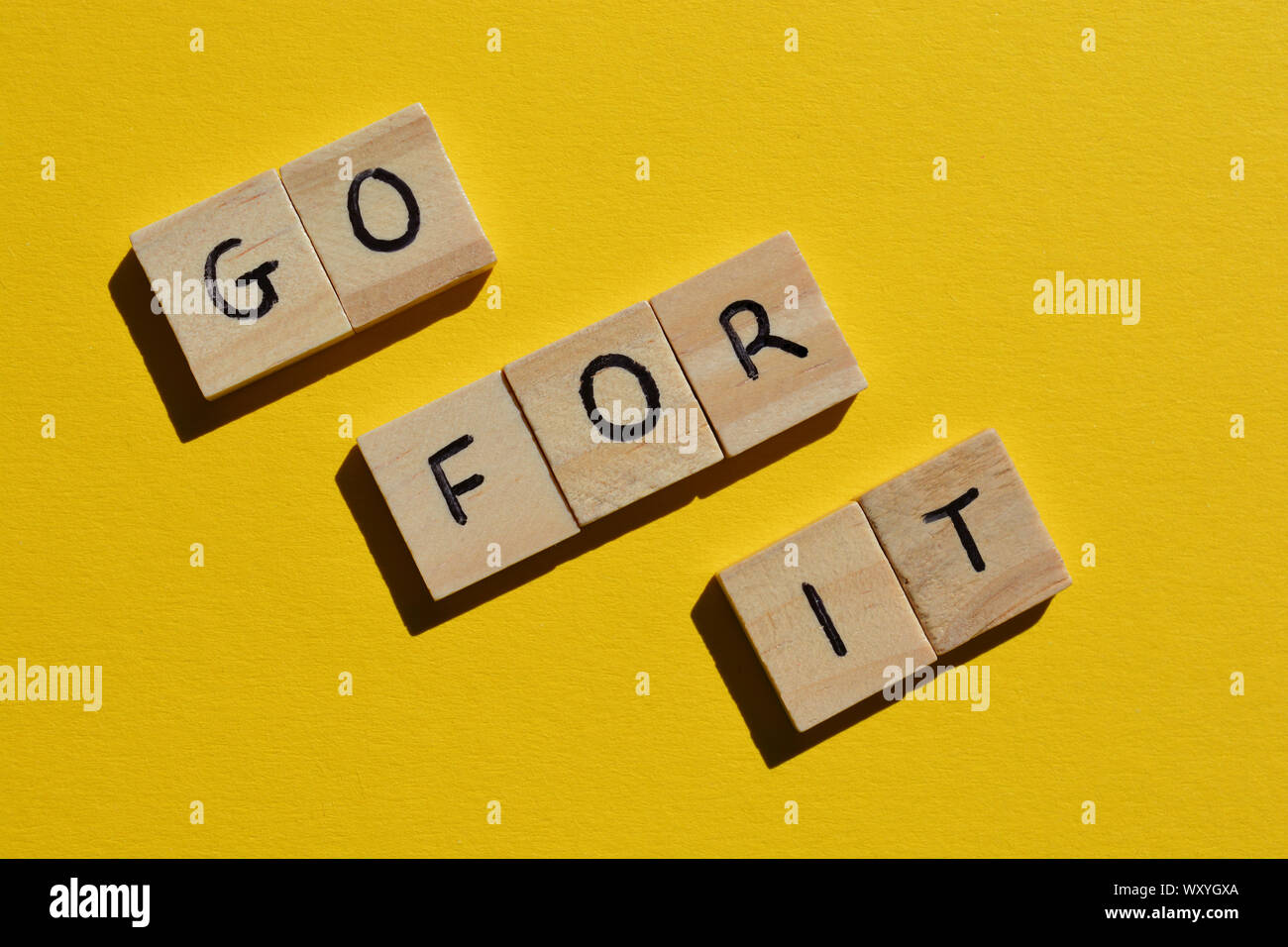 Go For It, motivational quote in wooden alphabet letters on yellow ...