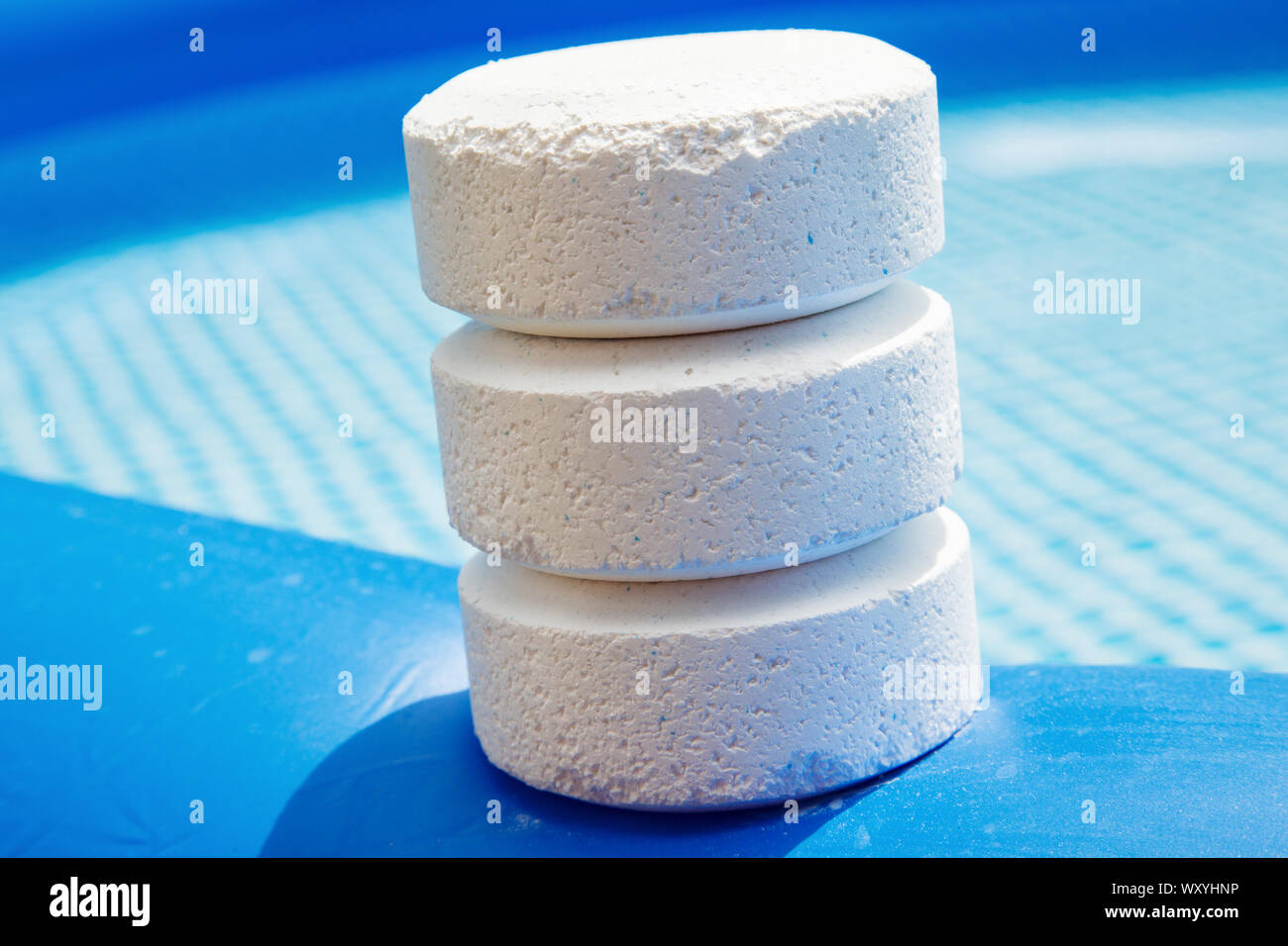 Chlorine Pellets on the edge of an inflatable pool Stock Photo - Alamy