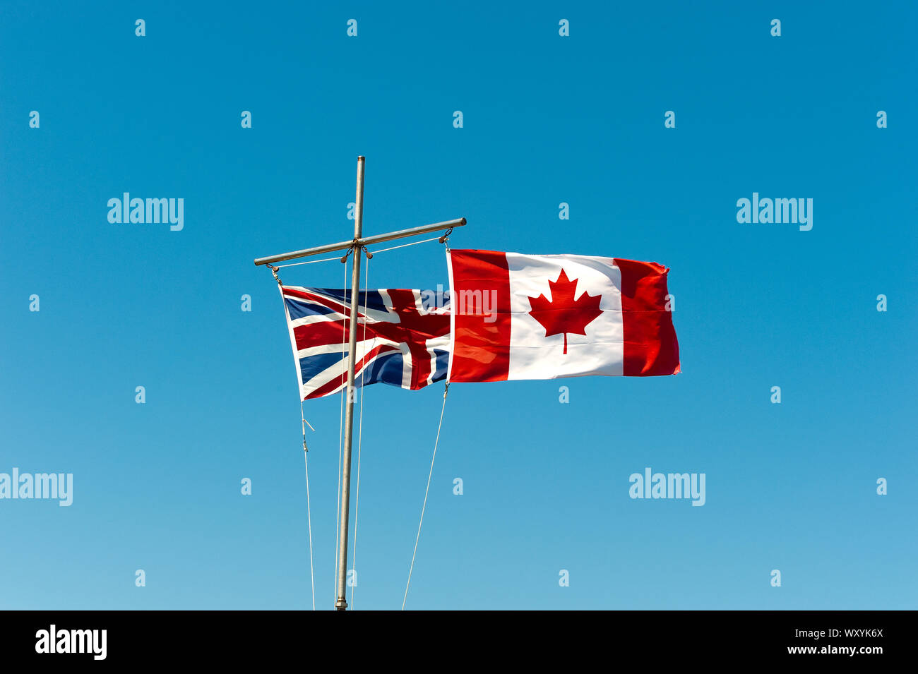 Canadian and British Flags flying together Stock Photo - Alamy