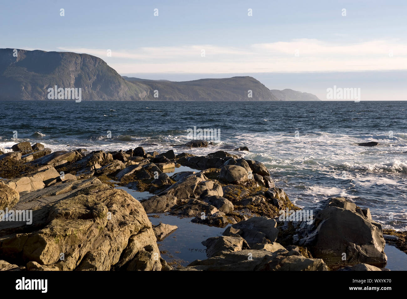 Jagged rocks and steep cliffs on shoreline Stock Photo - Alamy