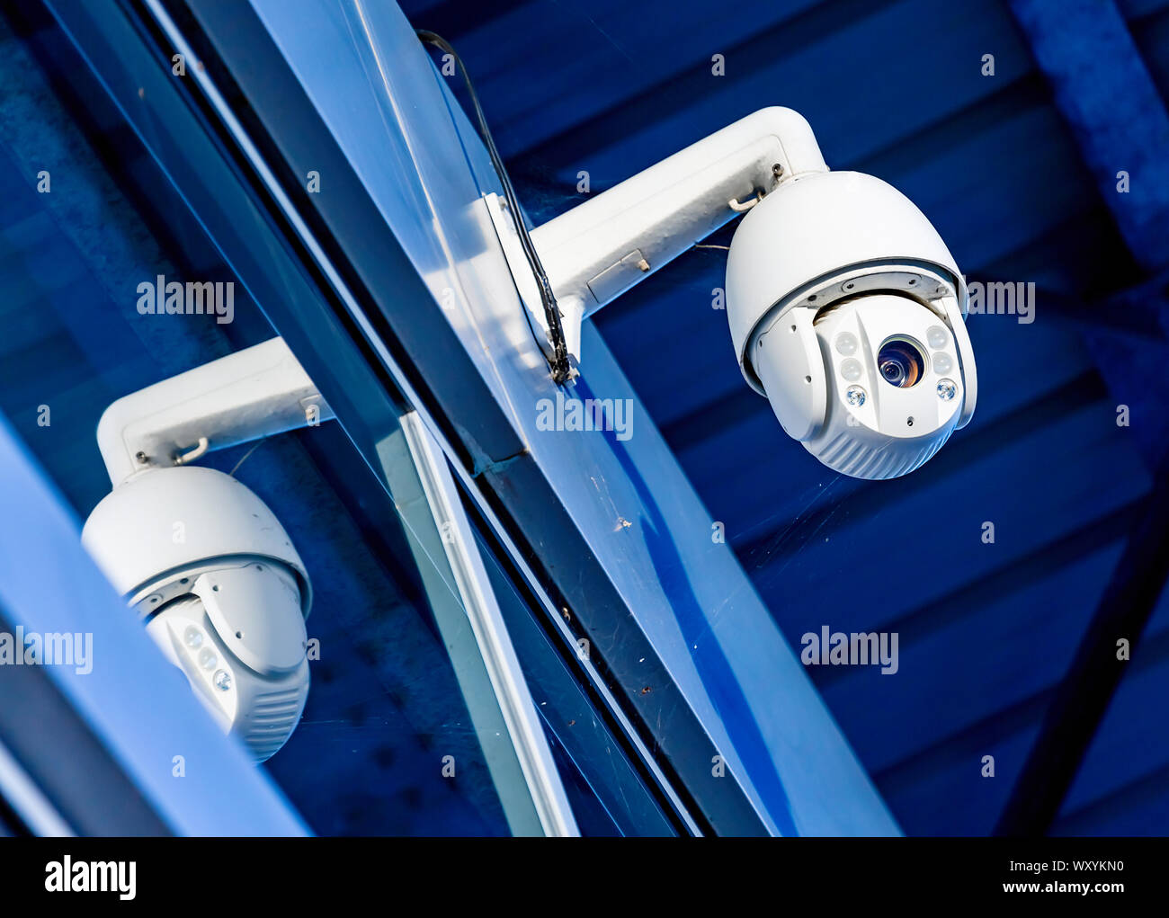 Close-up of modern CCTV camera on the wall of an industrial building ...