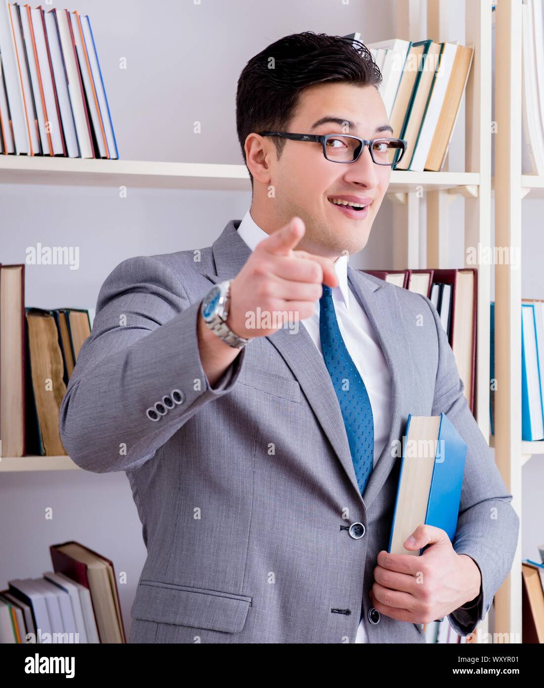 The businessman student reading a book studying in library Stock Photo ...