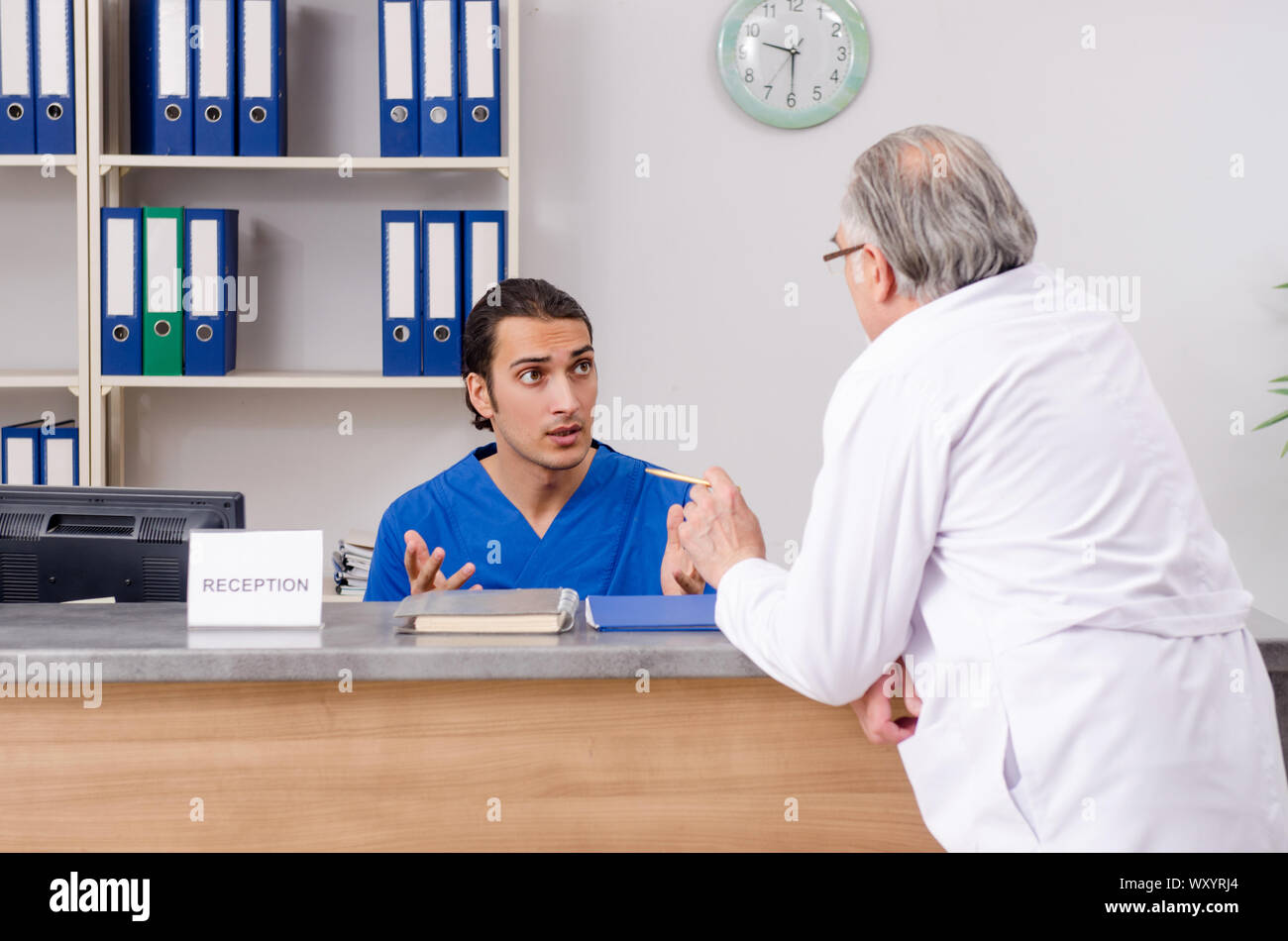 Doctors talking at the reception in hospital Stock Photo - Alamy